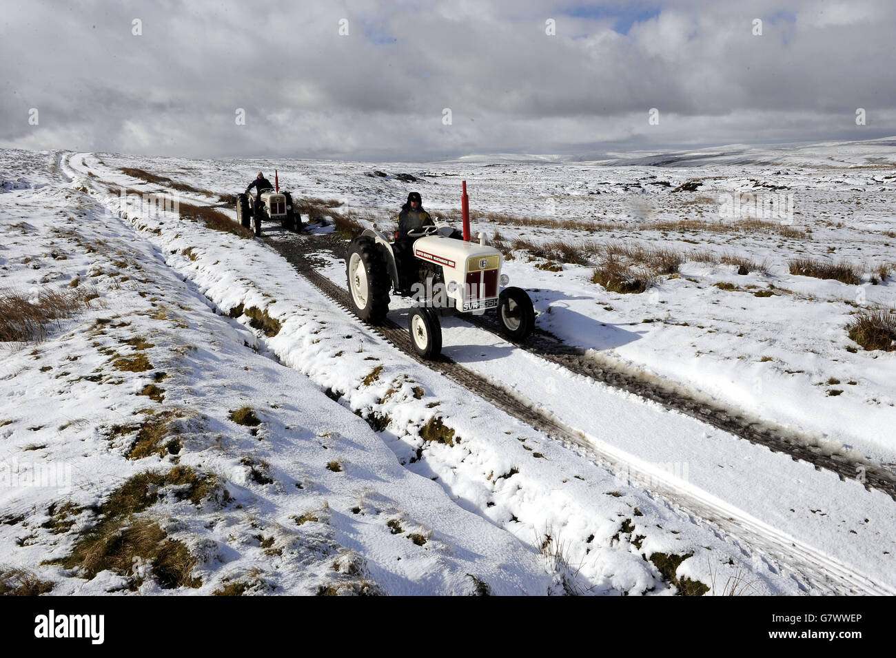 Martin Firth (right) and Des Woodhead drive their vintage tractors ...