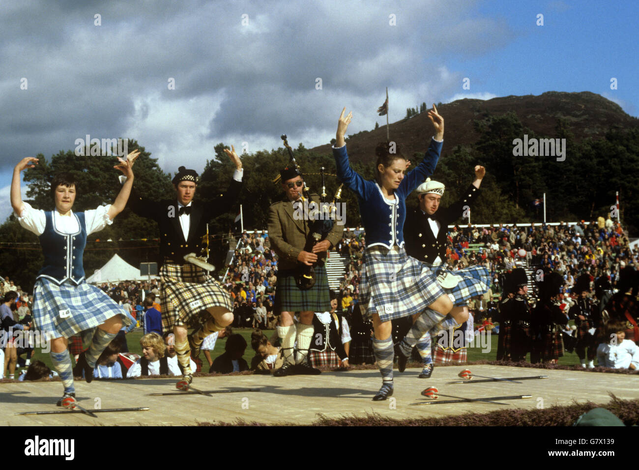 Male and female Scottish dancers competing in the traditional Sword ...