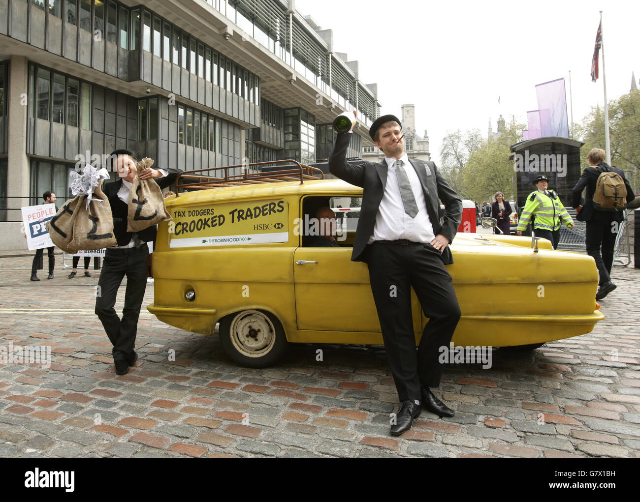 Protestors stand next to an 'Only Fool and Horses' type Robin Reliant ...