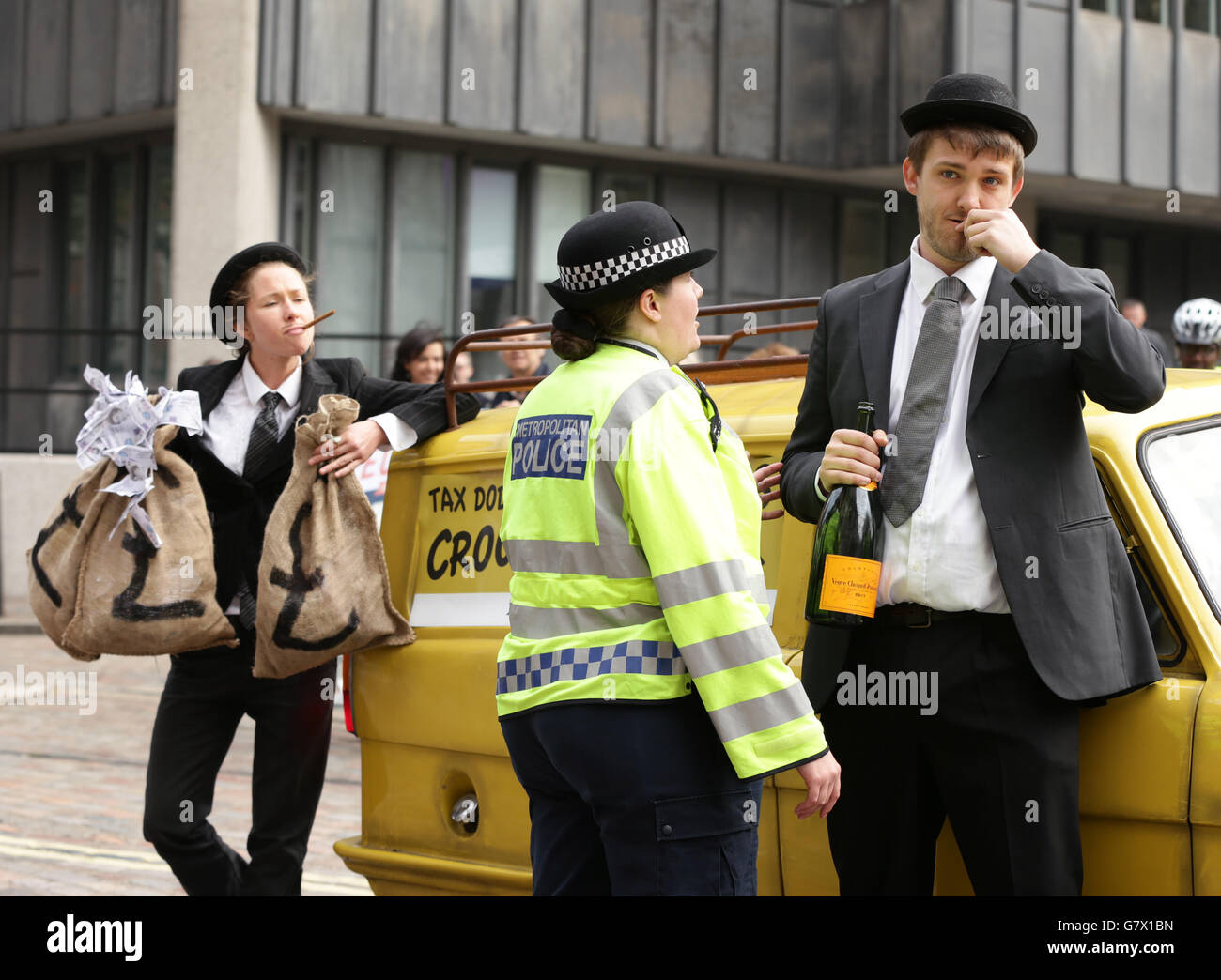 A police officer talks with protestors standing next to an 'Only Fool ...