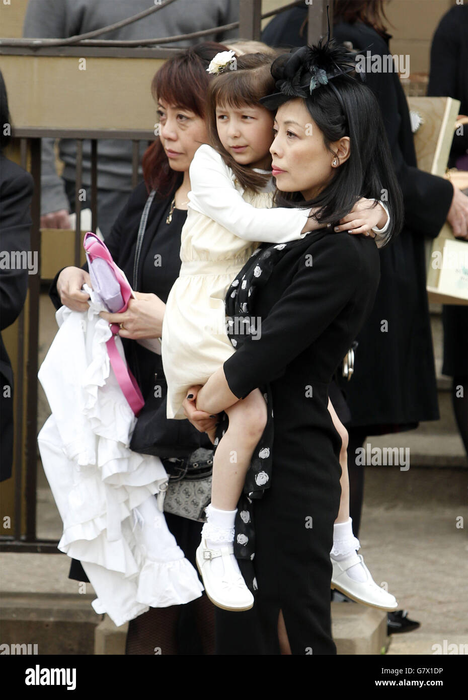 Widow Shuming McCabe holds daughter Ava McCabe outside St. Mary's ...