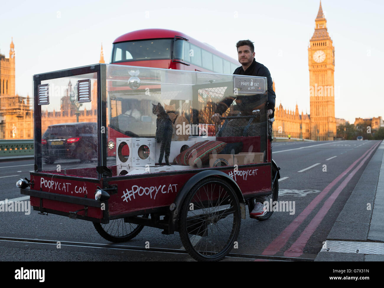 Poopy Cat Founder, Thomas Vles rides across Westminster Bridge in ...