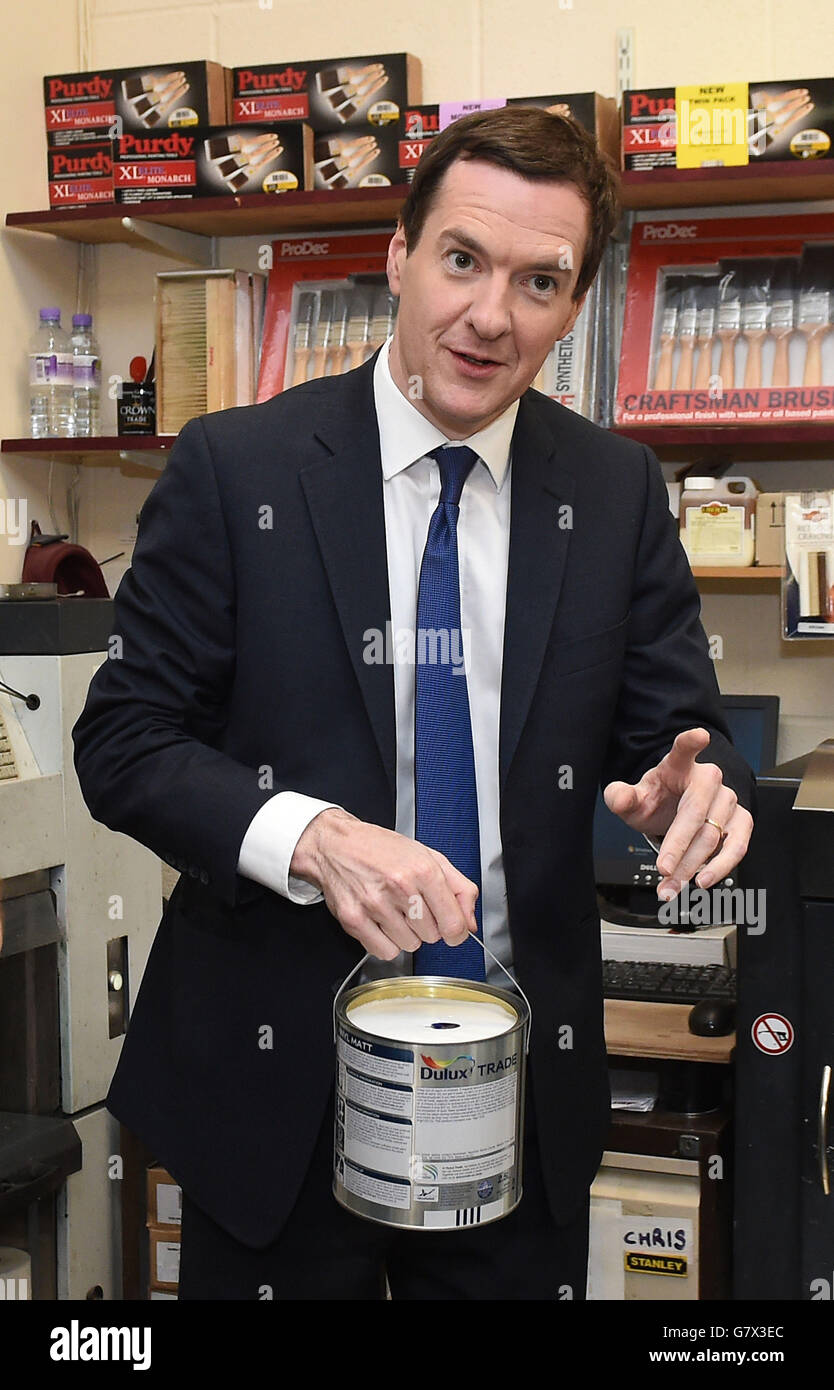 Chancellor George Osborne holds a tin of paint during his visit to ...
