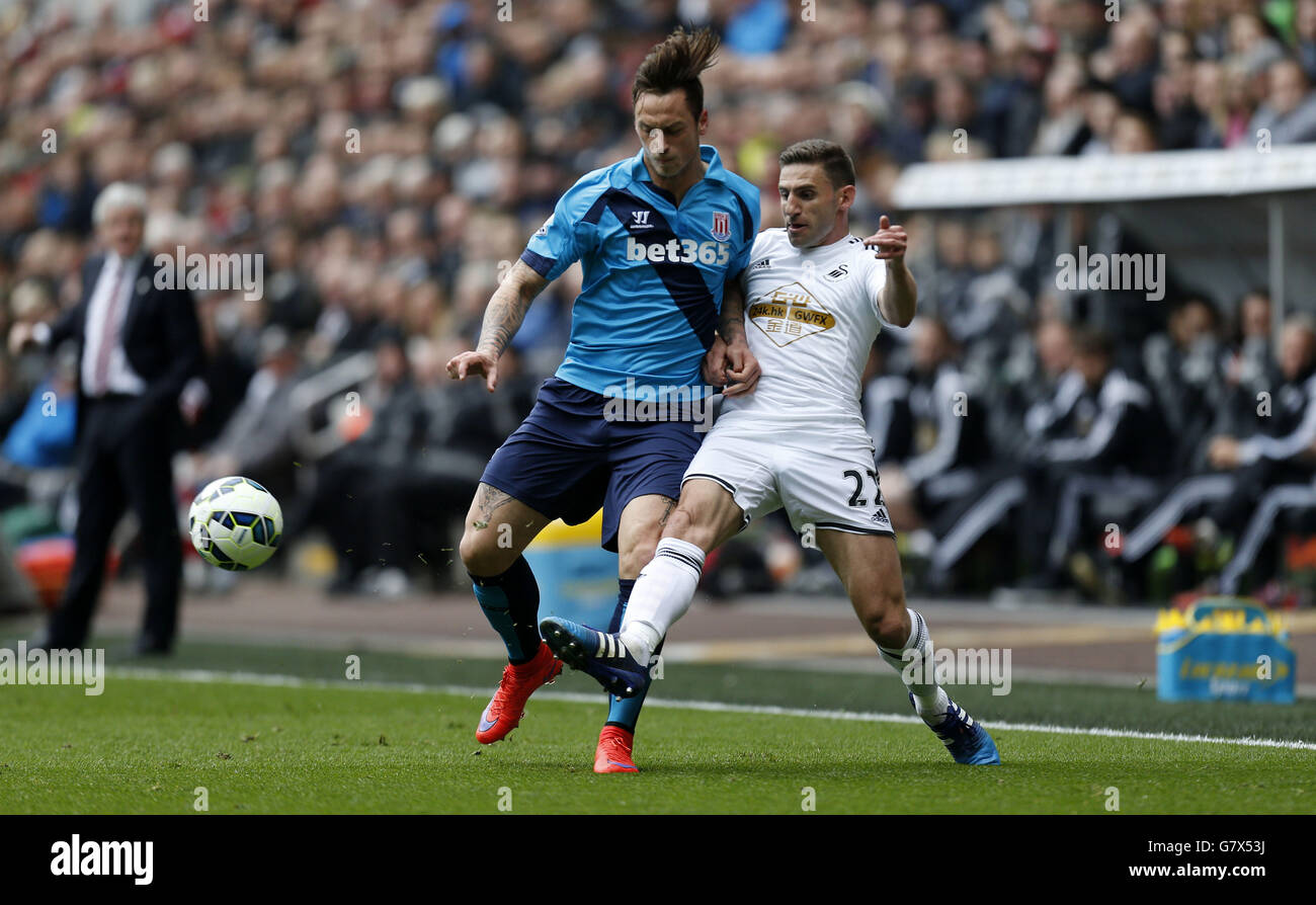 Swansea's Angel Rangel in action with Stoke's Marko Arnautovic during ...