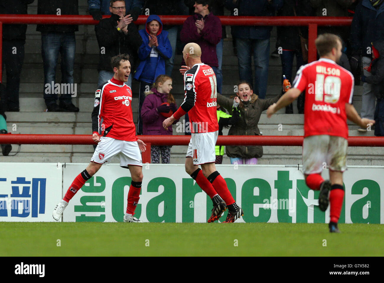Morecambe's Jamie Devitt (left) celebrates after he scores the third ...