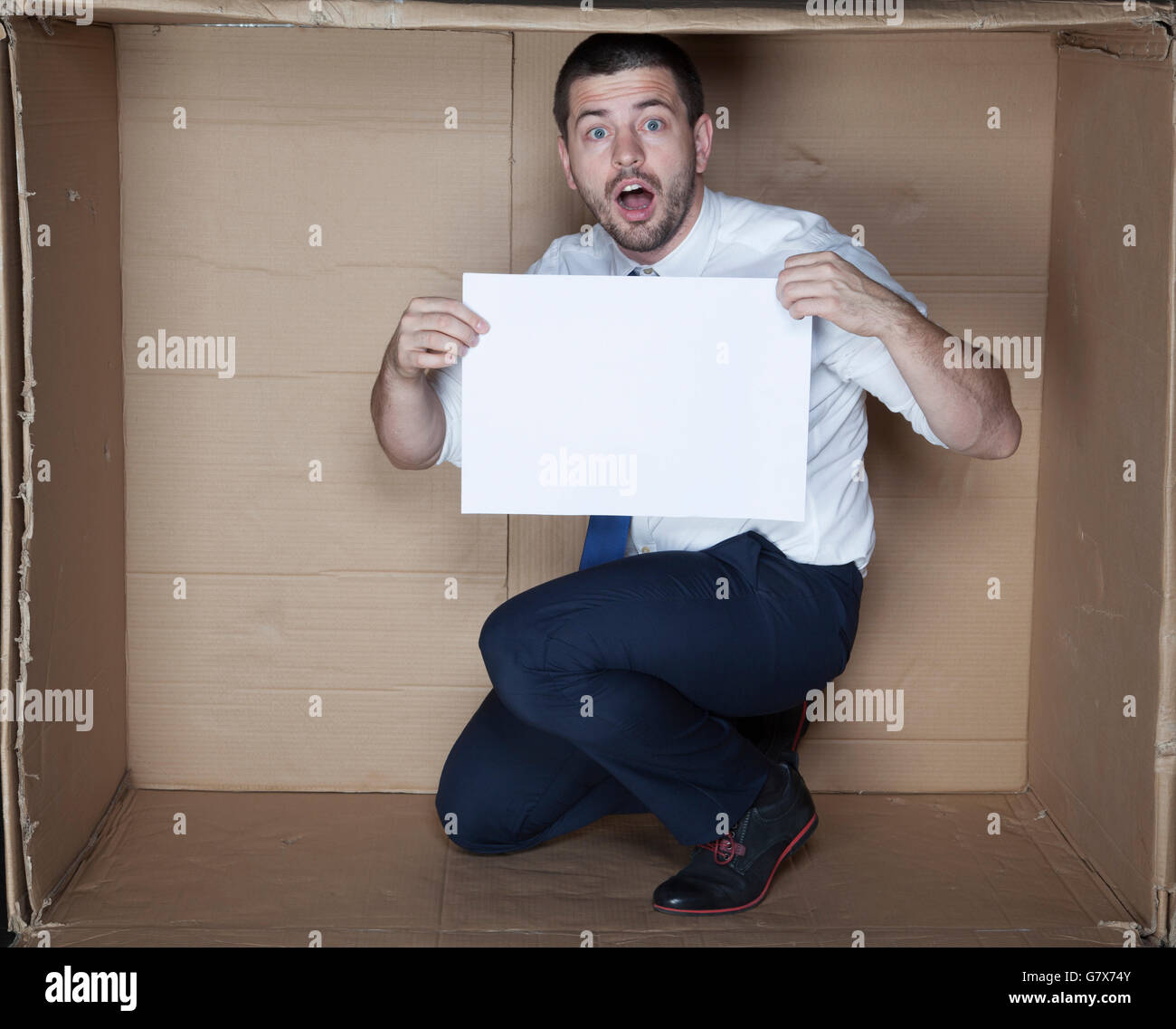 surprised businessman holding a piece of paper Stock Photo - Alamy