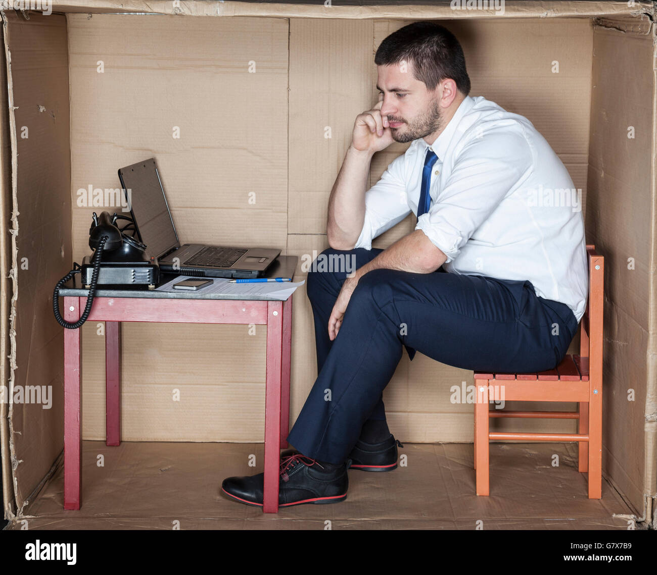 depressed businessman in a cardboard office Stock Photo - Alamy