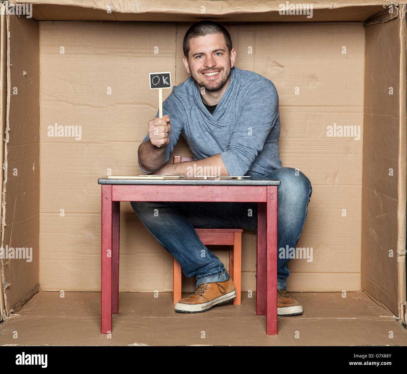 man in a box with a badge OK Stock Photo - Alamy