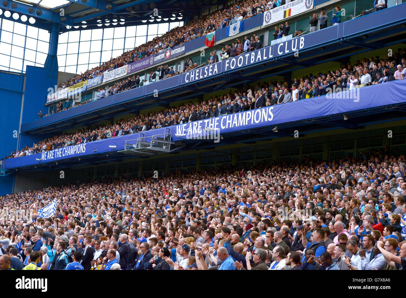 Chelsea fans celebrate in the stands surrounded by banners reading "We ...