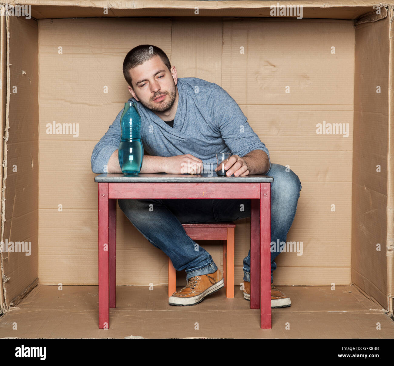 unemployed reaches for alcohol Stock Photo - Alamy