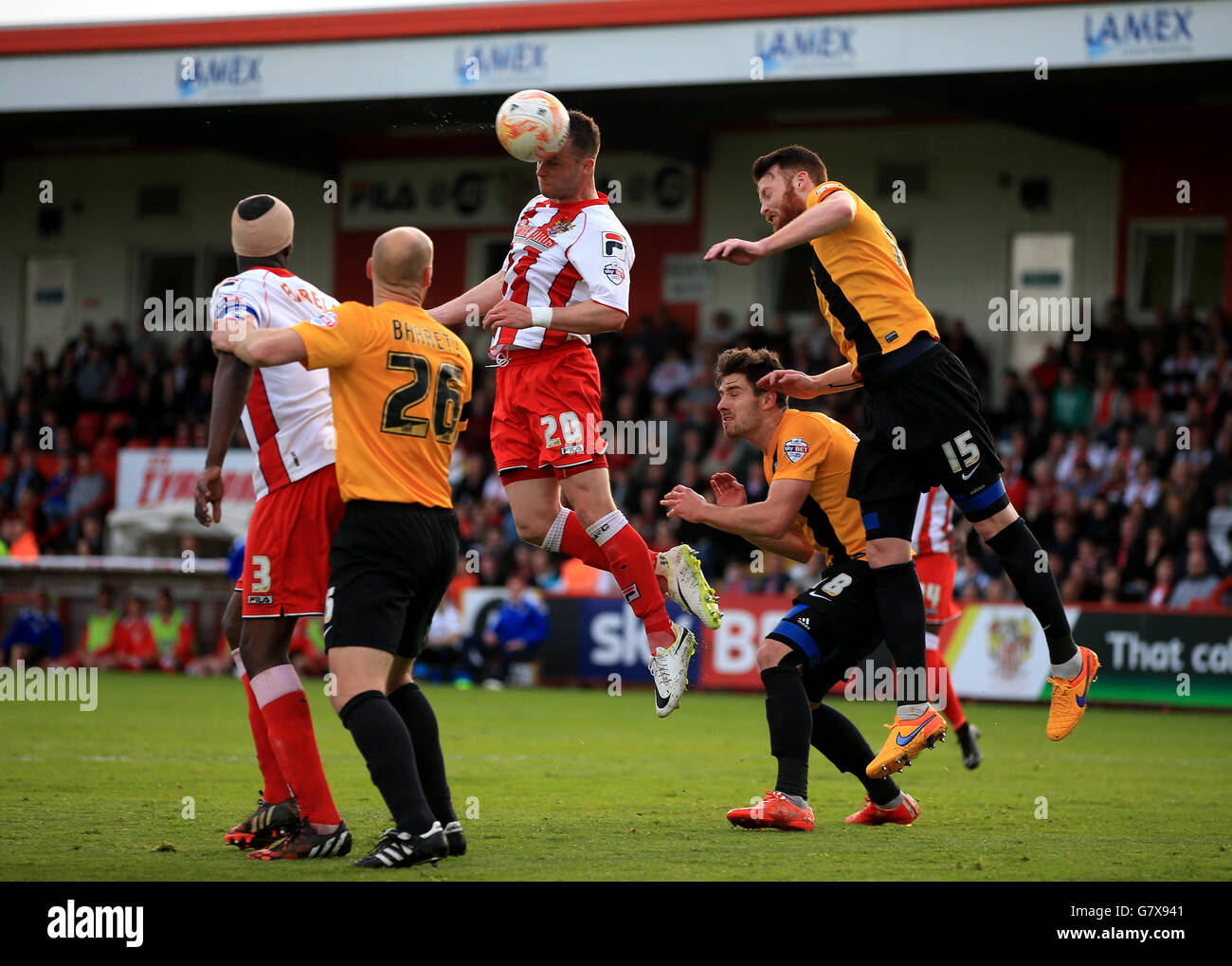 Stevenage's Chris Beardsley (centre) rises highest to win the ball ...