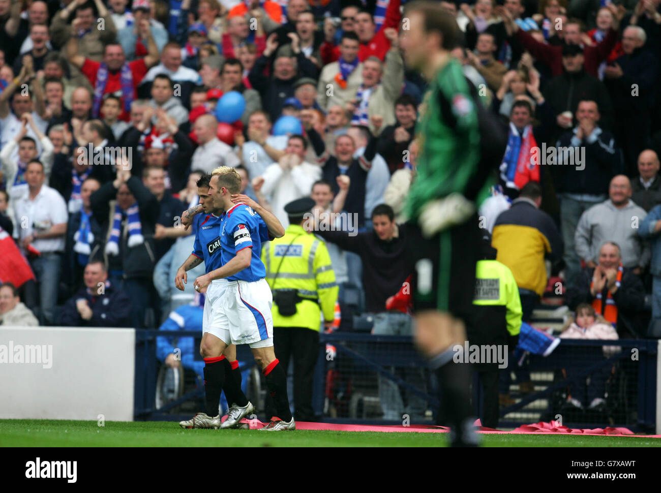 A dejected Motherwell goalkeeper Gordon Marshall as Rangers celebrate ...