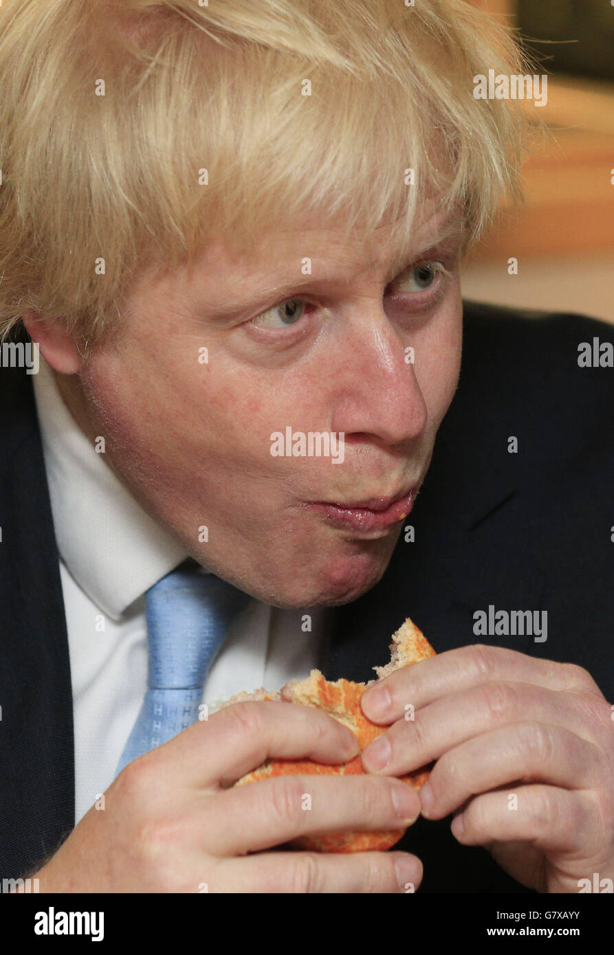Mayor of London, Boris Johnson eats a bacon sandwich as he visits the ...