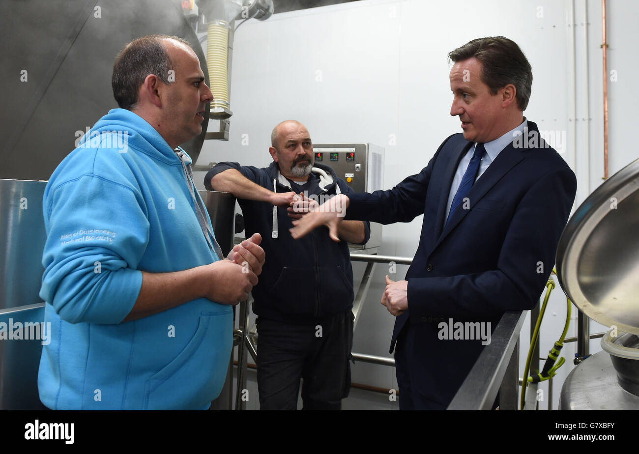 Prime Minister David Cameron talks through the brewing process with ...