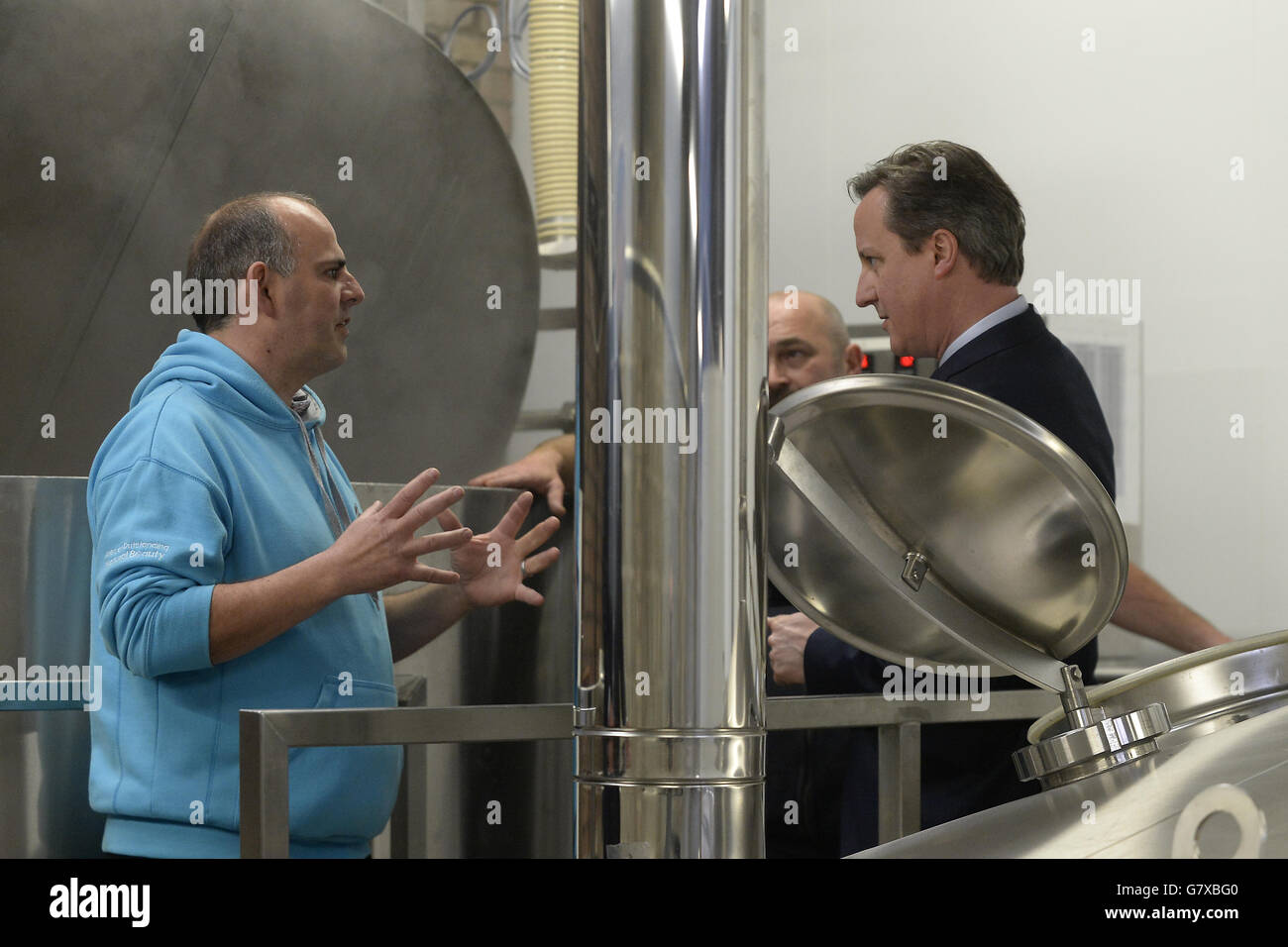 Prime Minister David Cameron talks through the brewing process with ...