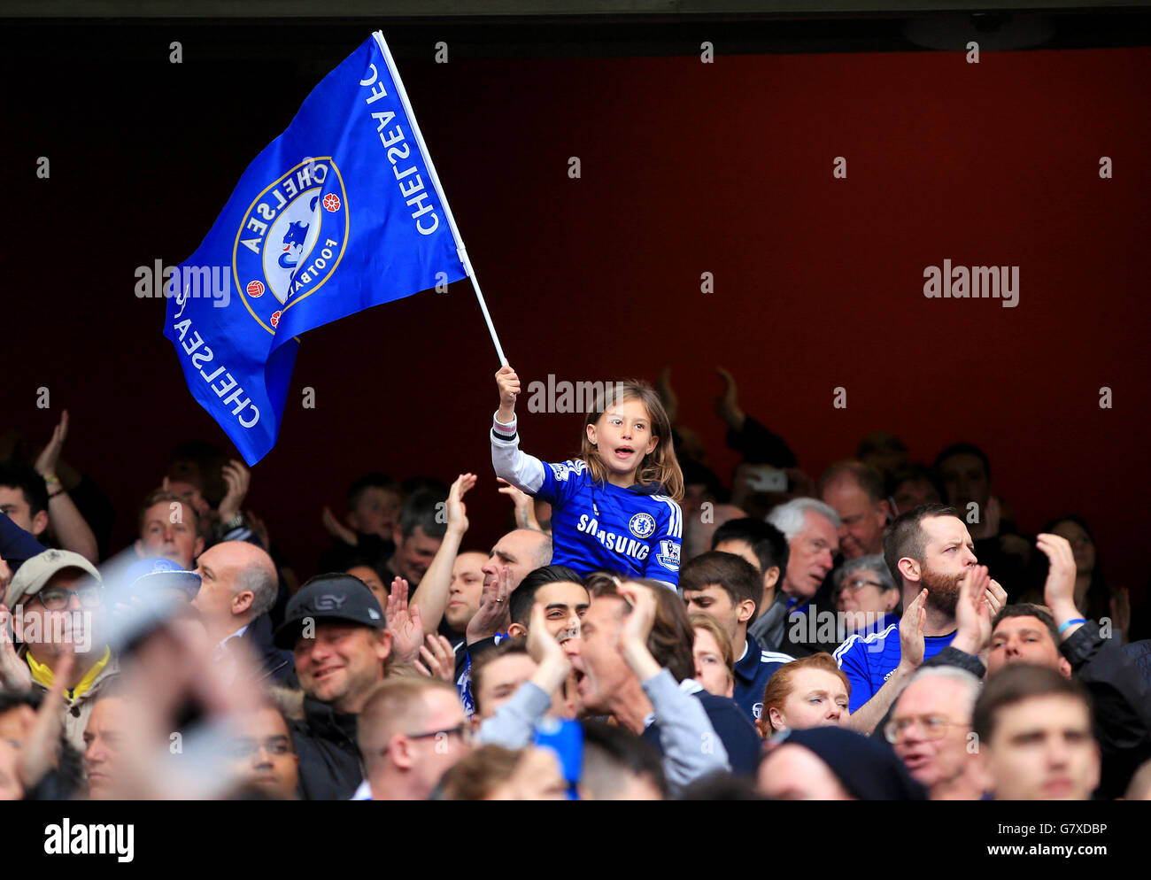 A Chelsea fan shows her support with a team flag in the stands during ...