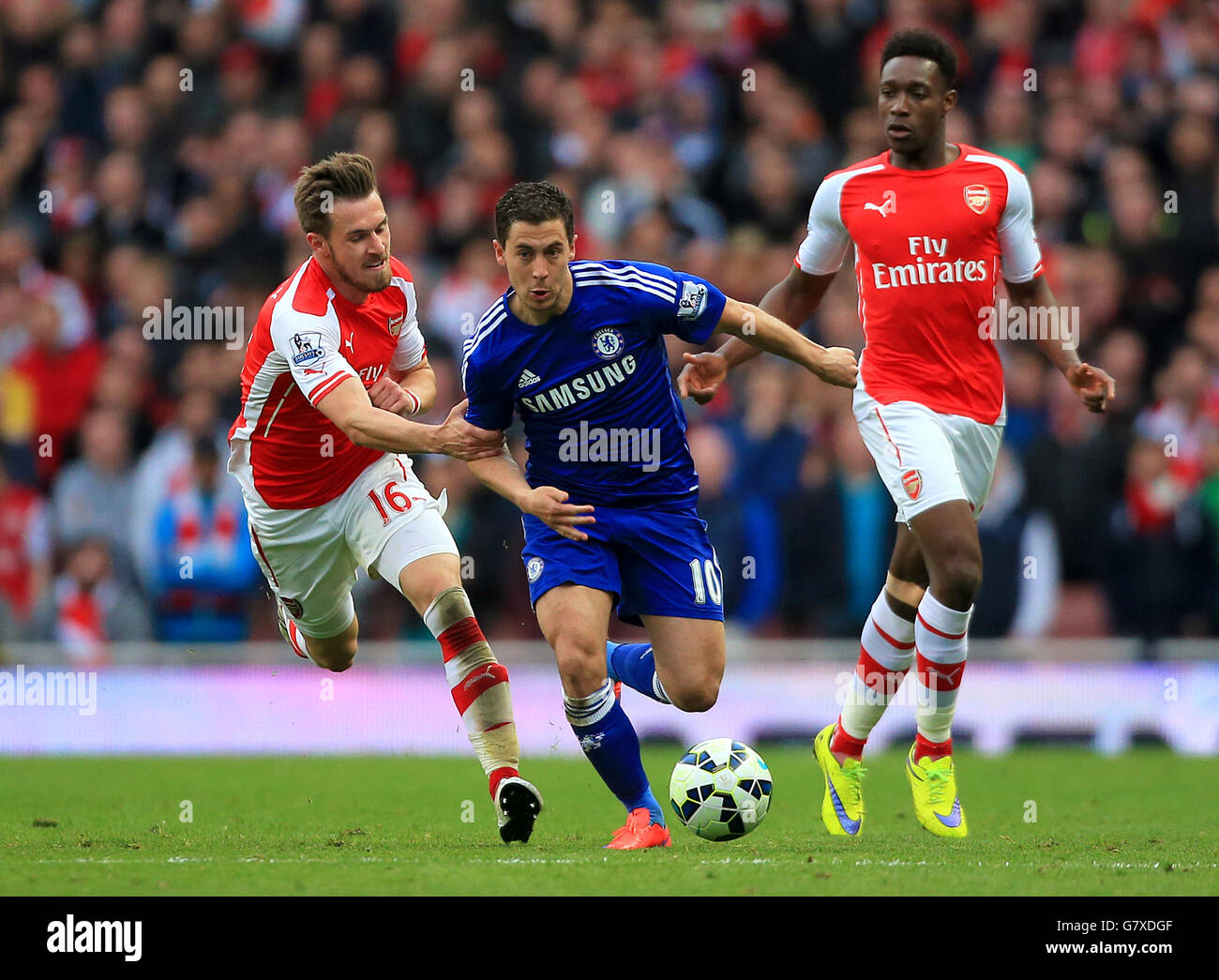 Chelsea's Eden Hazard (centre) in action with Arsenal's Aaron Ramsey ...