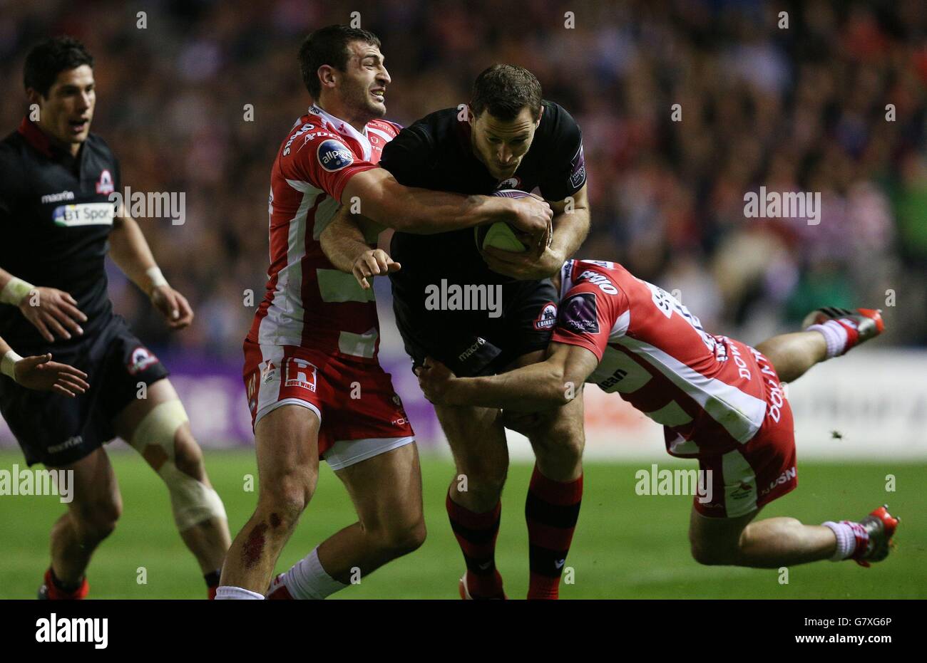 Edinburgh's Tim Visser is tackled by Gloucester's Charlie Sharples and ...