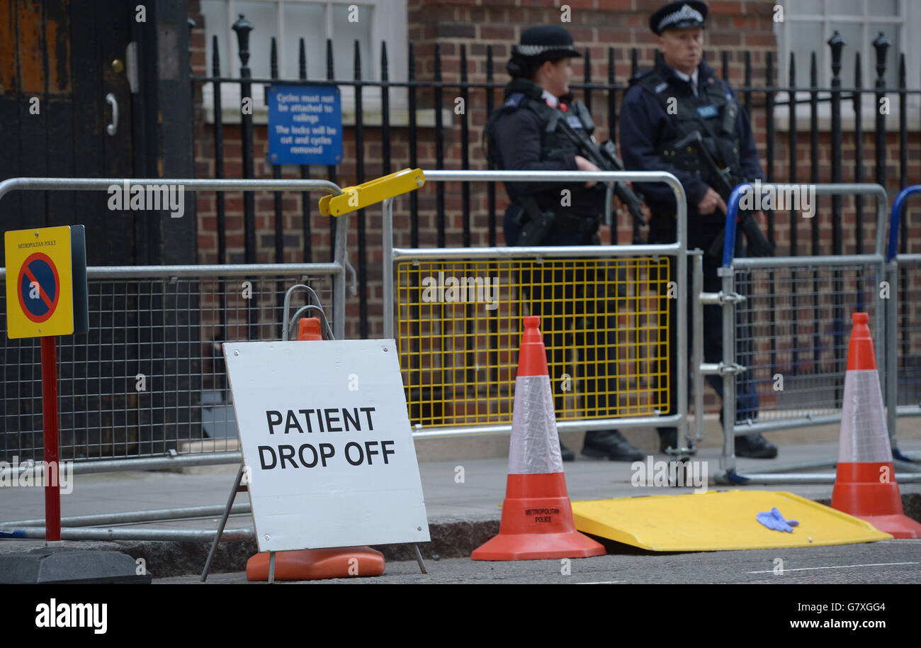Police wait outside the Lindo wing of St Mary's Hospital in Paddington ...