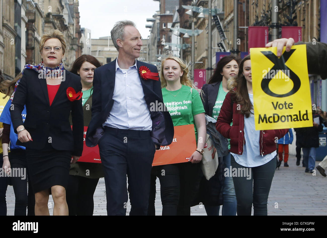 A protester holds an SNP poster as comedian Eddie Izzard and Scottish ...