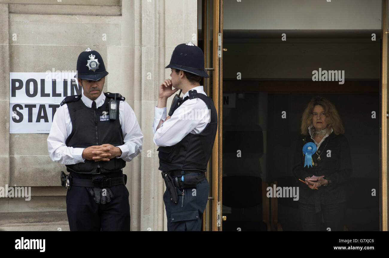Police officers stand outside polling station at westminster central ...