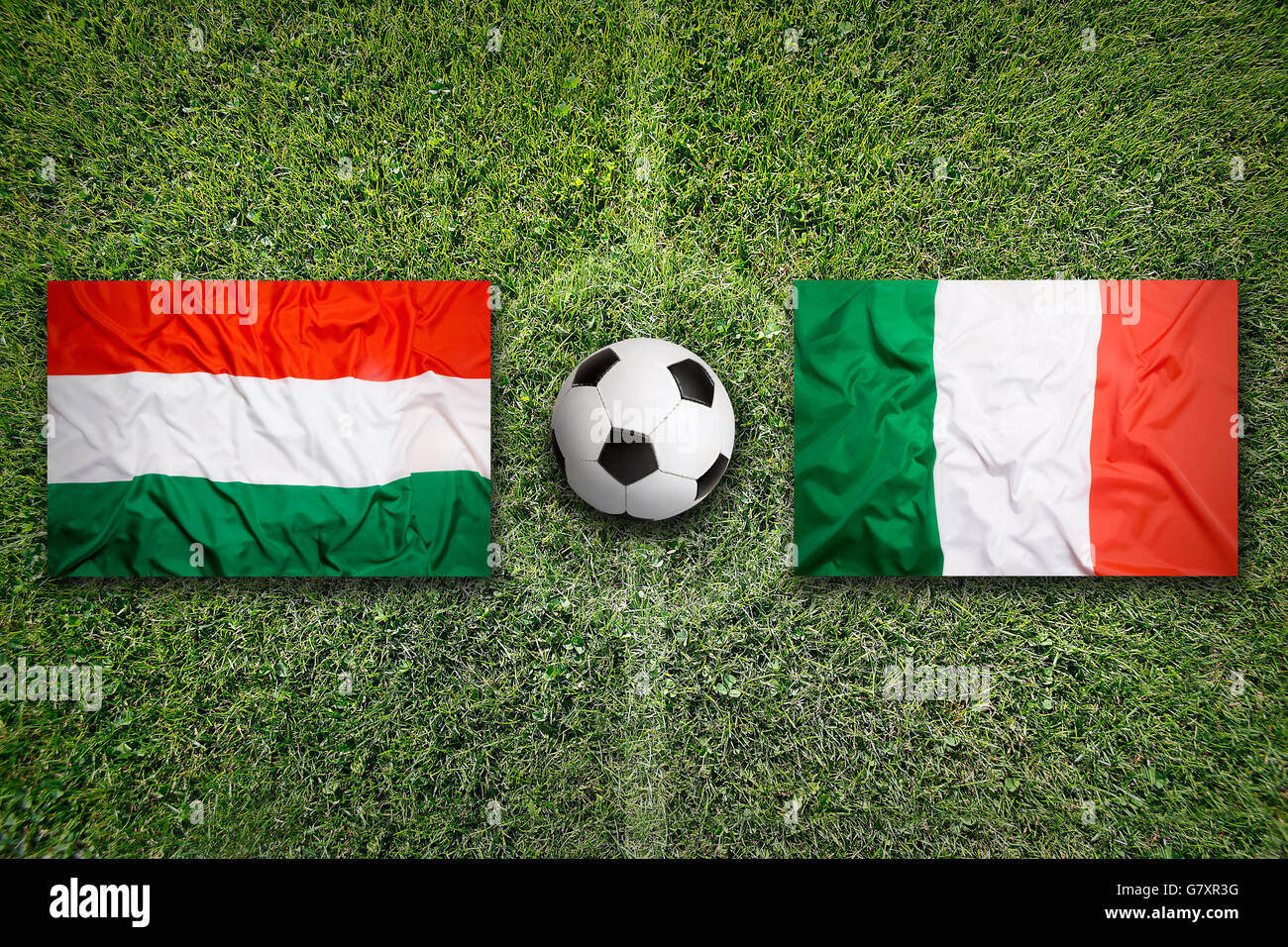 Hungary vs. Italy flags on green soccer field Stock Photo - Alamy