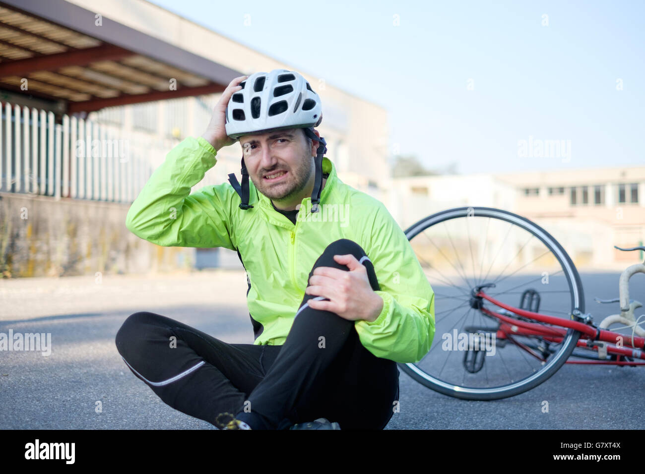 Aching man after bicycle accident on the asphalt Stock Photo - Alamy