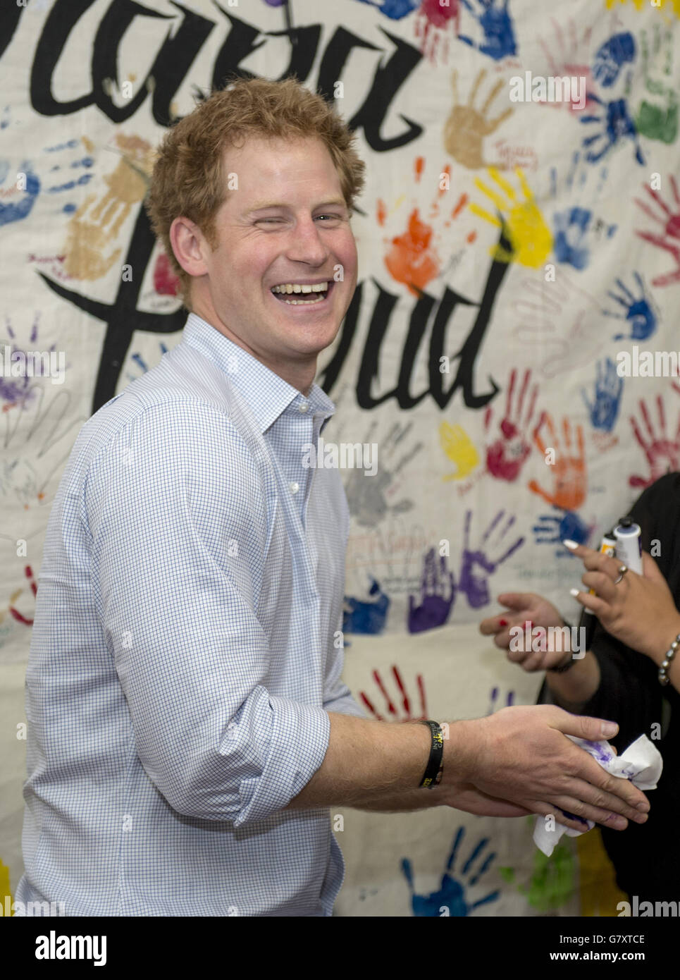 Prince Harry puts his handprint on a poster during his visit to Turn ...