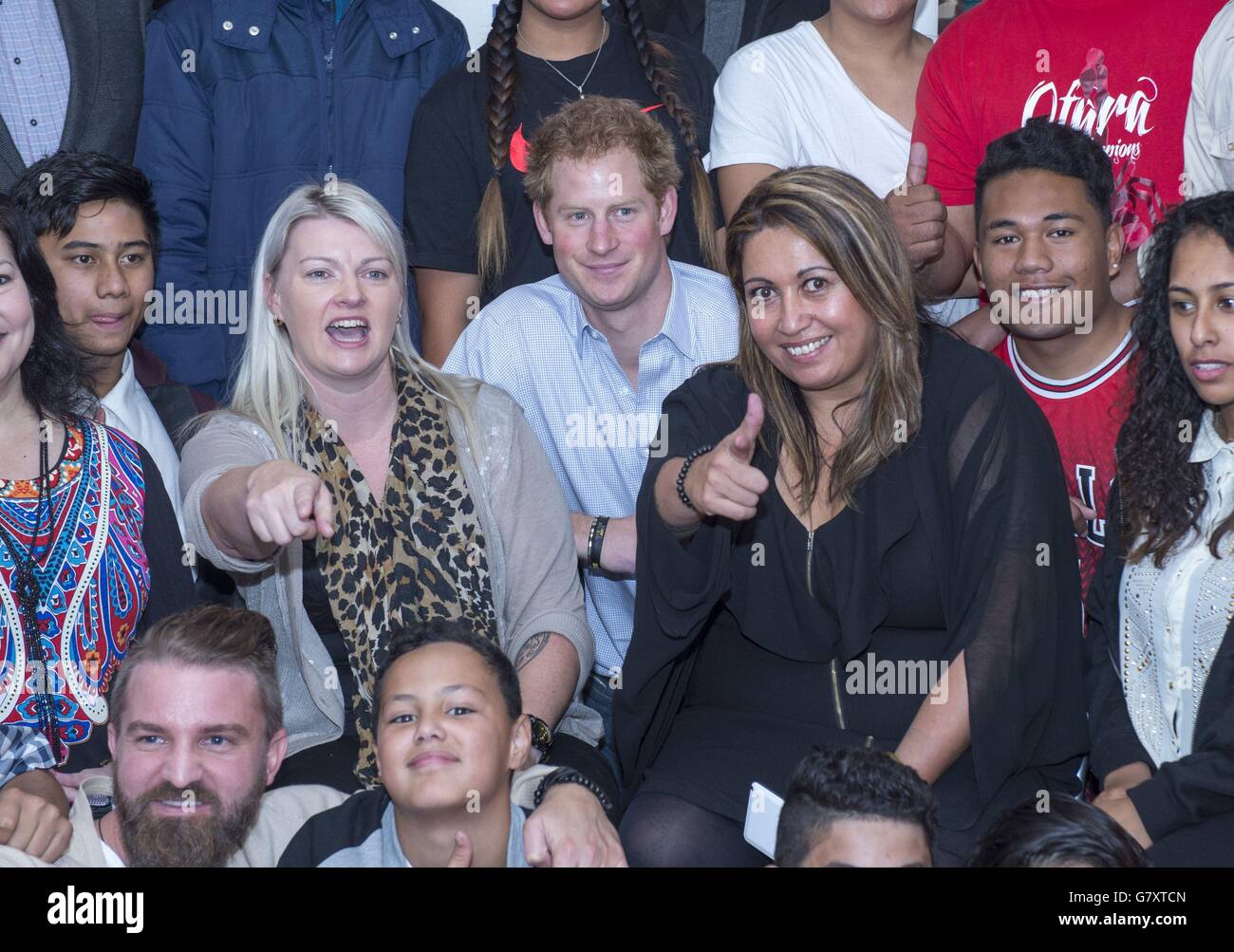 Prince Harry poses with staff and teenagers during his visit to Turn ...