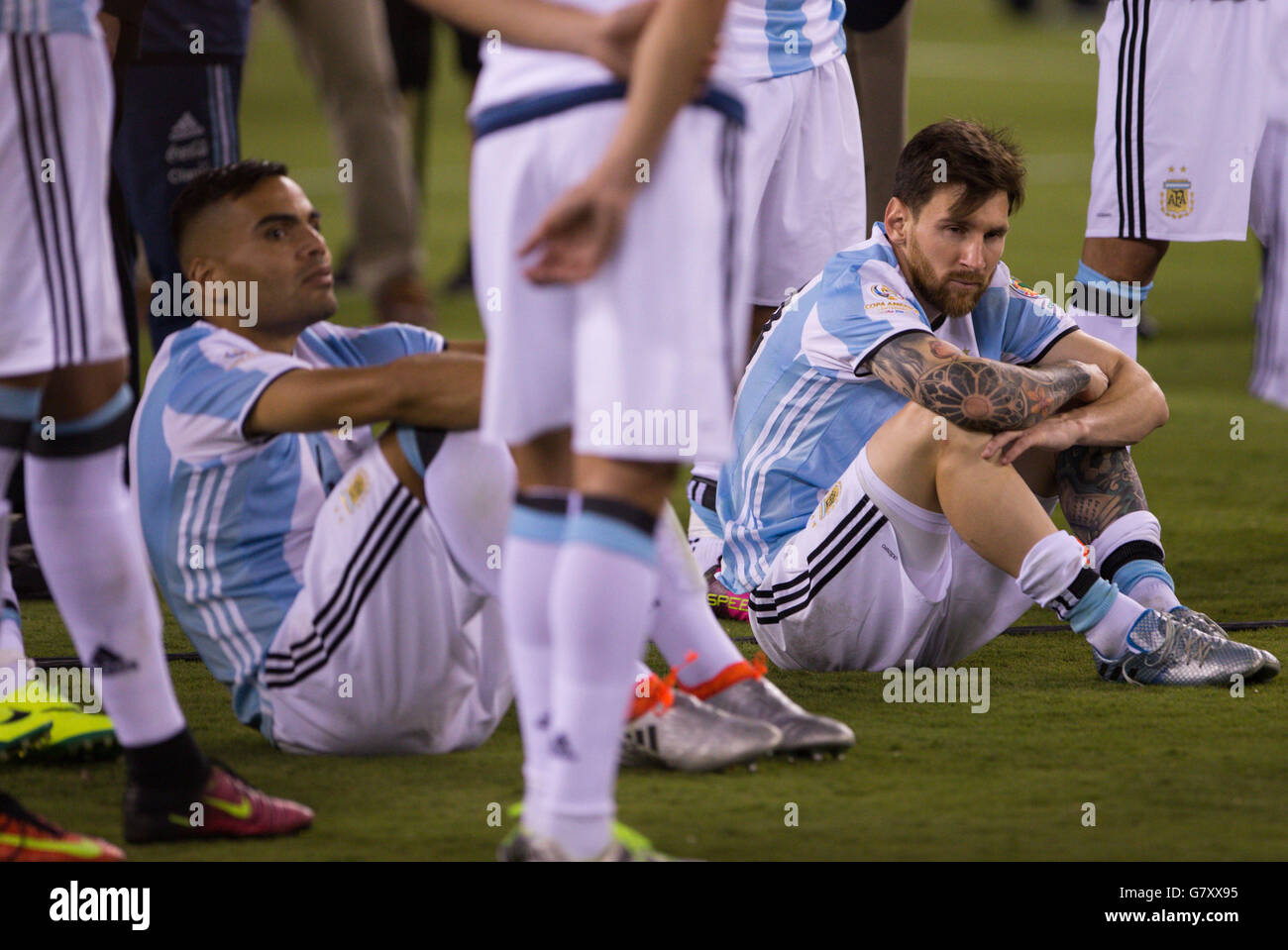 New Jersey, USA. 26th June, 2016. Argentina's Lionel Messi (R) sits on ...