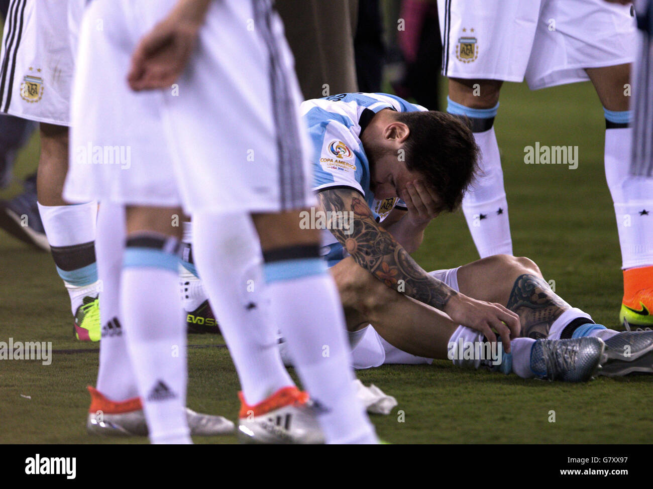 New Jersey, USA. 26th June, 2016. Argentina's Lionel Messi (R) sits on ...