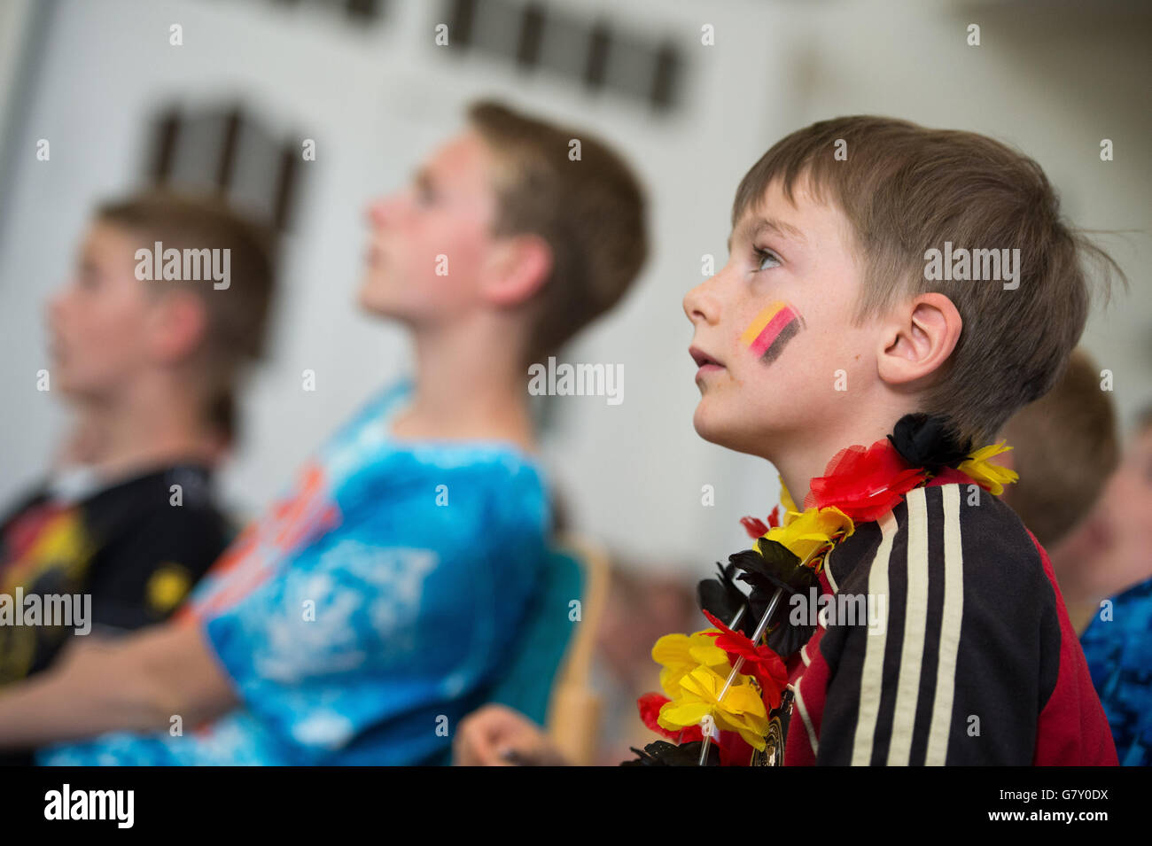 A boy with a German flag on his cheek attends a public viewing of the ...