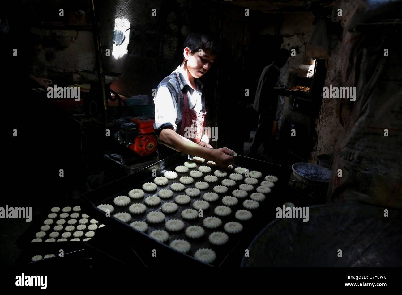 Kabul, Afghanistan. 27th June, 2016. An Afghan boy makes cakes for the ...