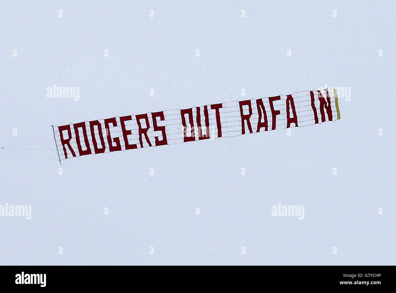 A plane flies a banner displaying 'Rodgers Out Rafa In' before the ...