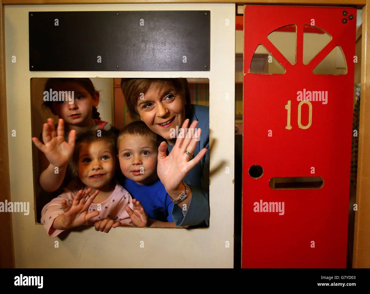 First Minister Nicola Sturgeon in a playhouse with children as she ...
