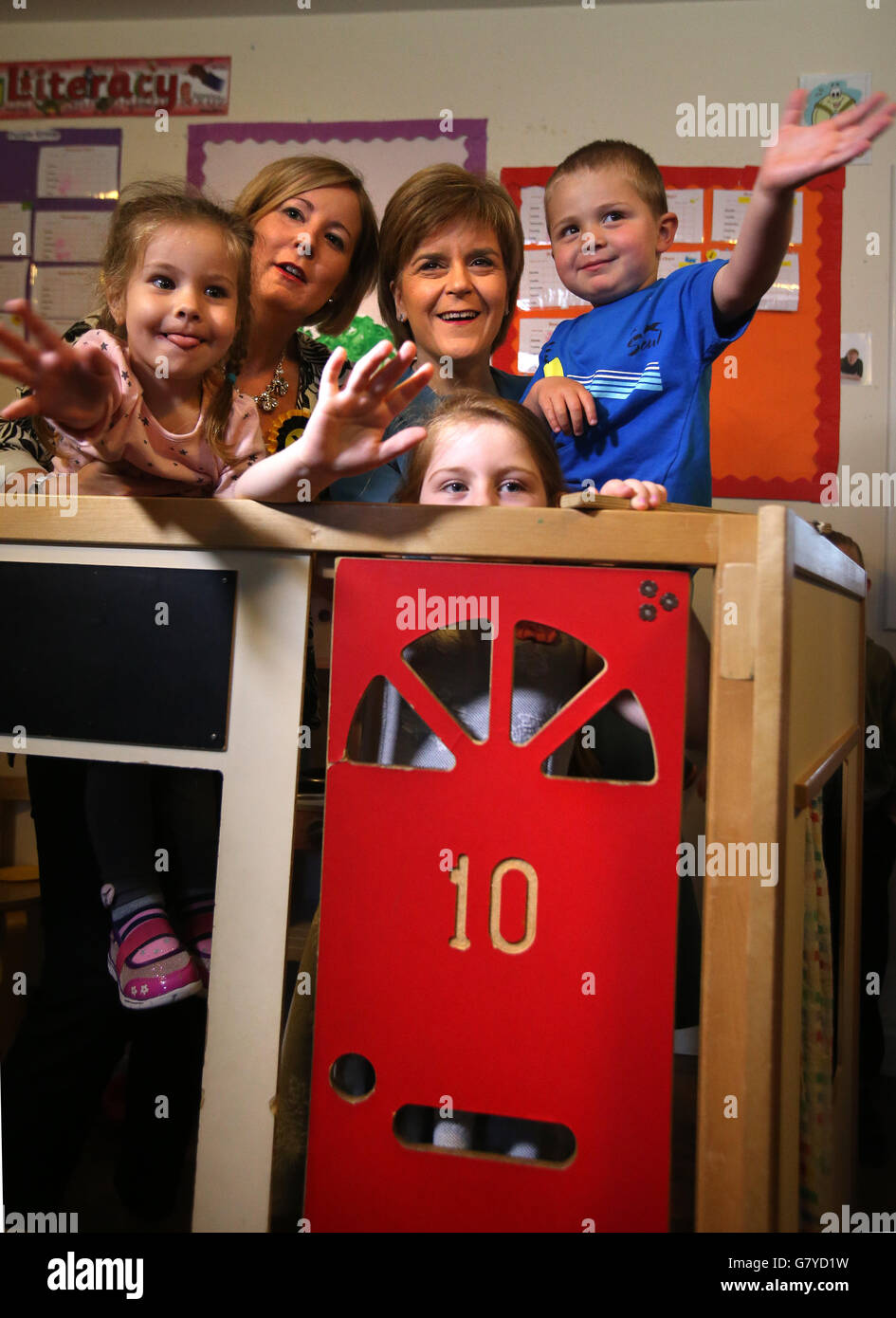 First Minister Nicola Sturgeon in a playhouse with children as she ...