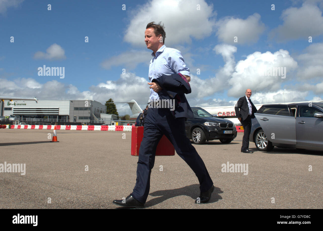 Prime Minister David Cameron boards a plane at Luton Airport for his ...