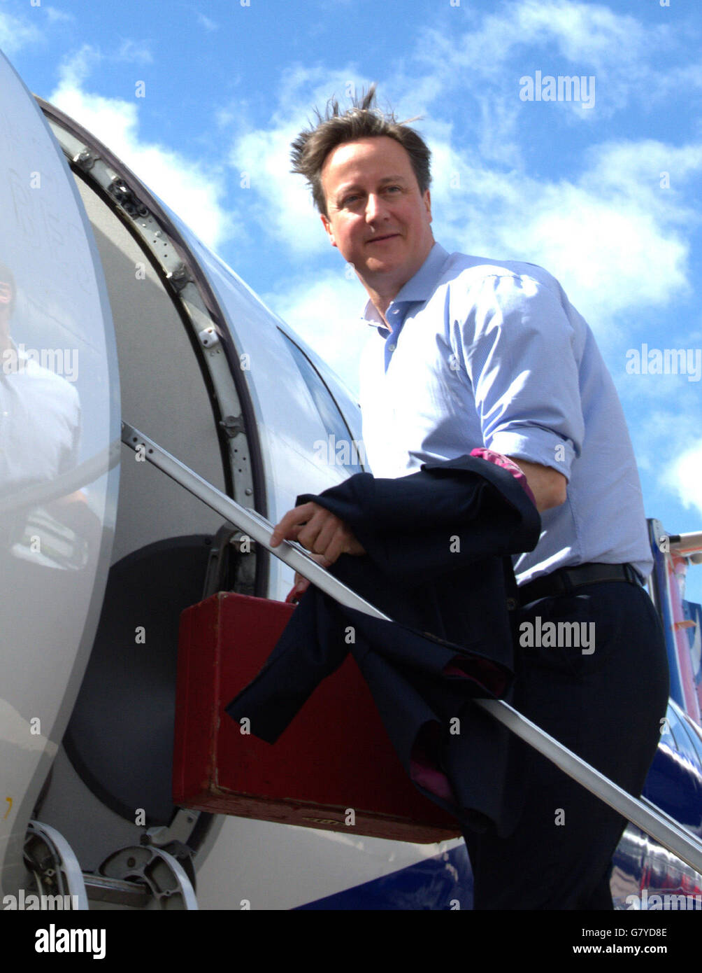 Prime Minister David Cameron boards a plane at Luton Airport for his ...