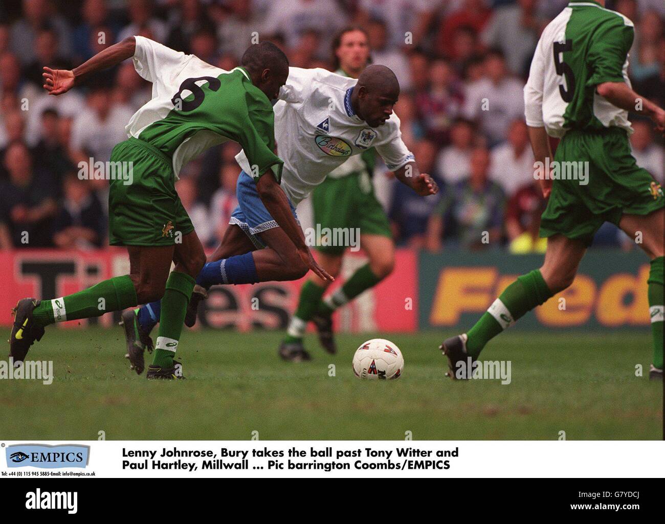 Lenny Johnrose, Bury takes the ball past Tony Witter and Paul Hartley ...