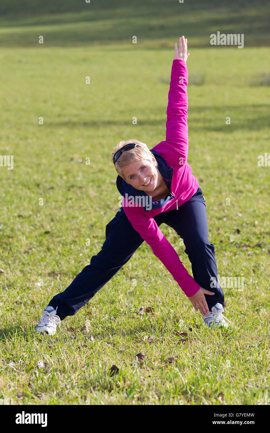 Young woman doing gymnastics on the lawn Stock Photo - Alamy