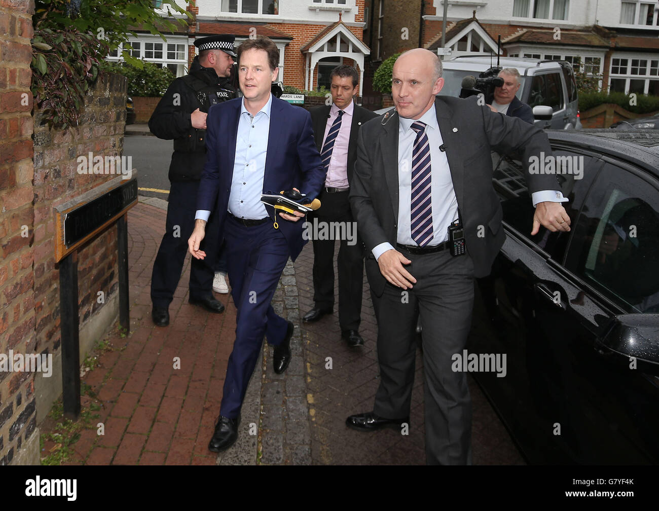 Nick Clegg (centre left) arrives back at his home after he earlier ...