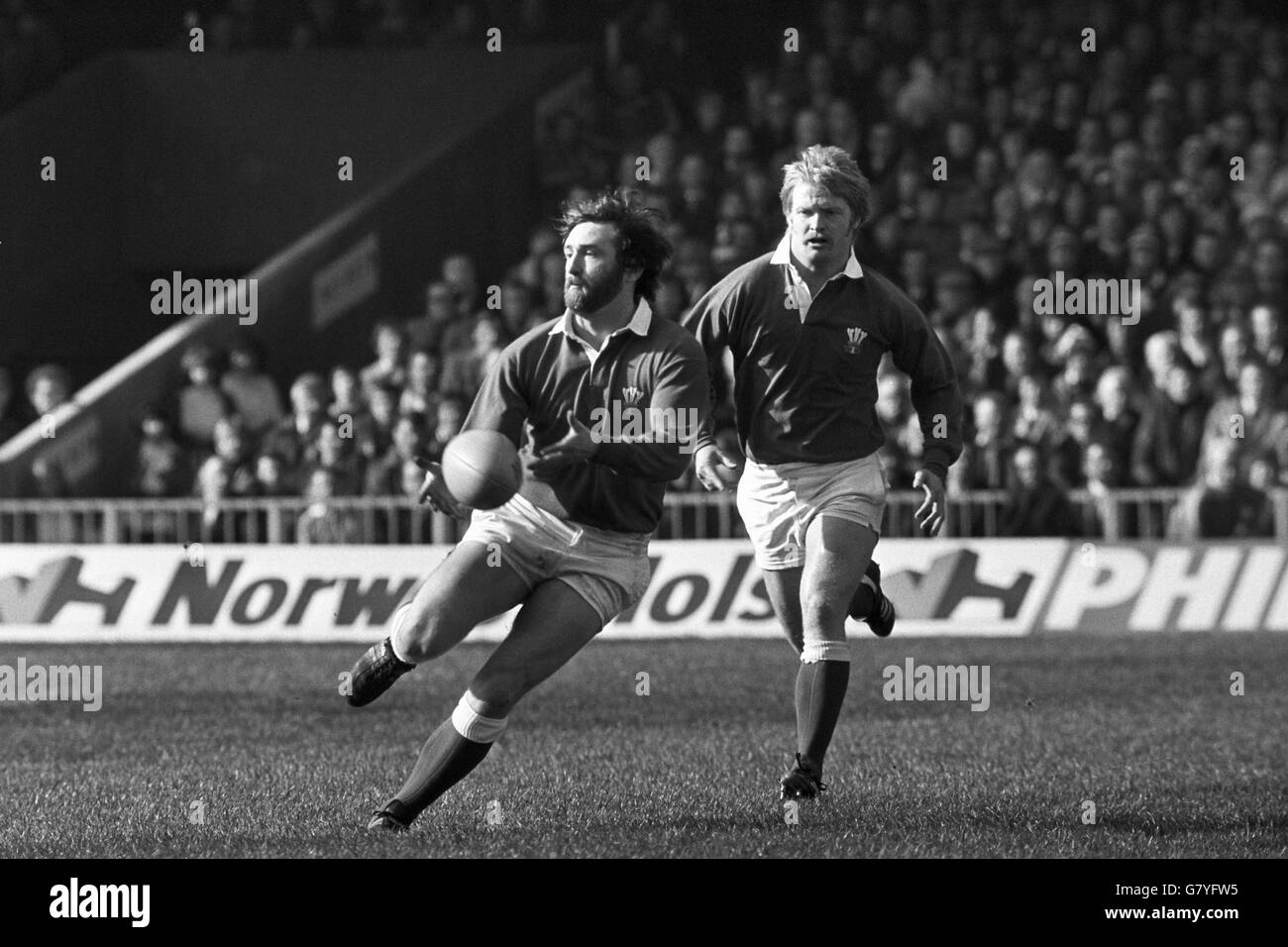 Wales' Ray Gravell (l) passes the ball, watched by teammate Steve ...