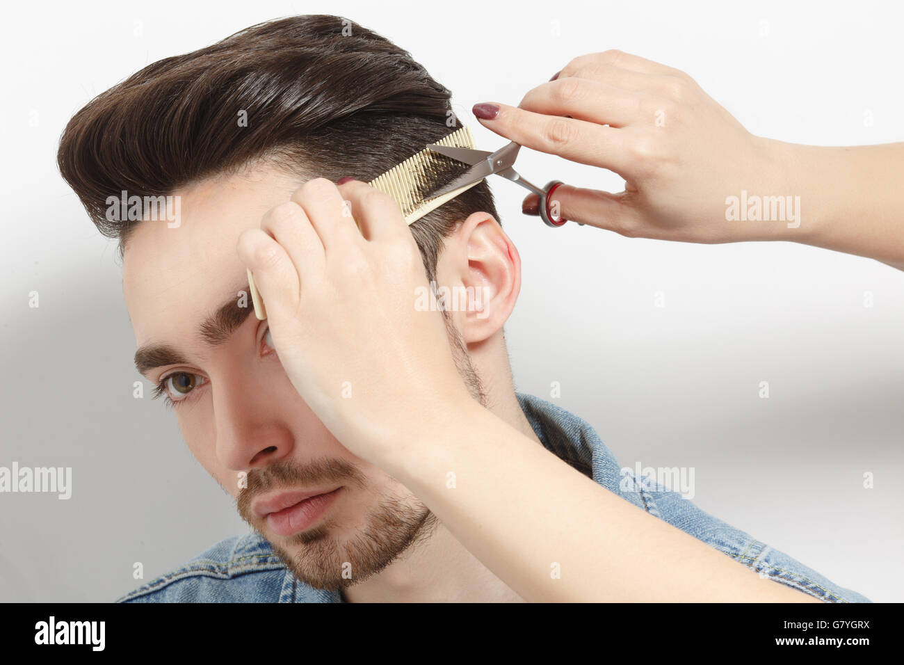 Handsome man having haircut Stock Photo - Alamy