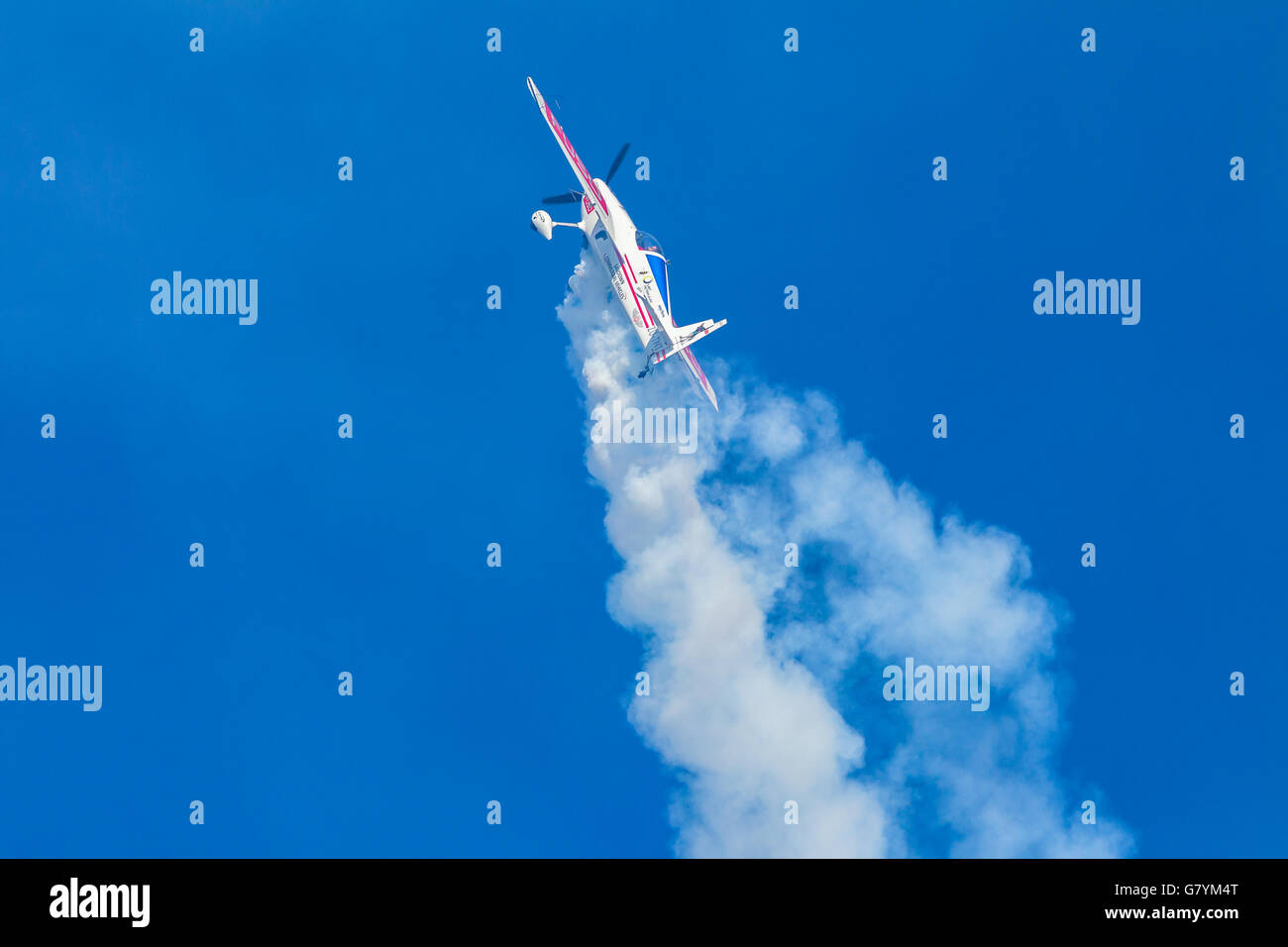 Aircraft acrobatics plane pilot flying action in blue sky closeup ...