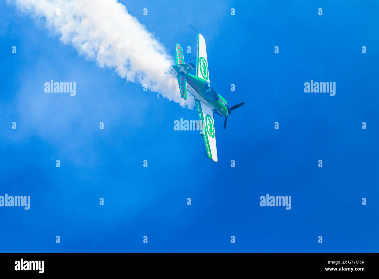 Aircraft acrobatics plane pilot flying action in blue sky closeup ...
