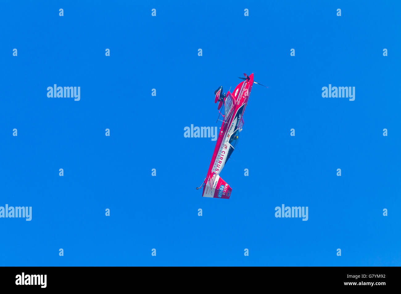 Aircraft acrobatics plane pilot flying action in blue sky closeup ...