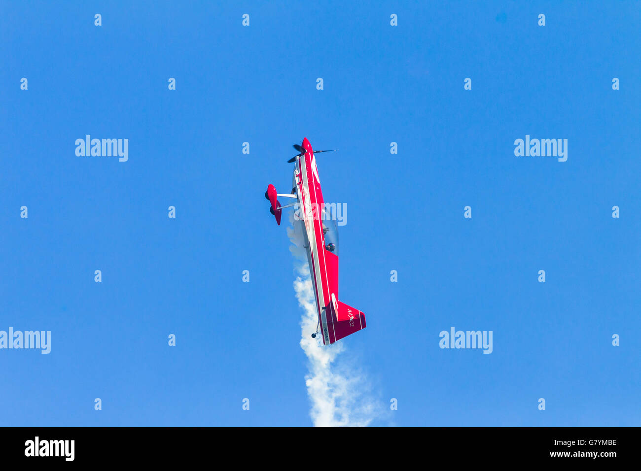 Aircraft acrobatics plane pilot flying action in blue sky closeup ...