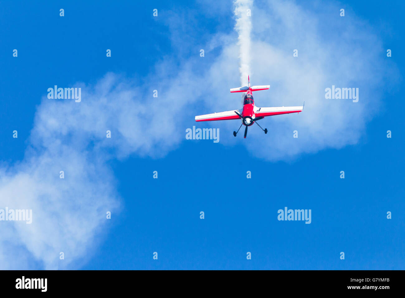 Aircraft acrobatics plane pilot flying action in blue sky closeup ...