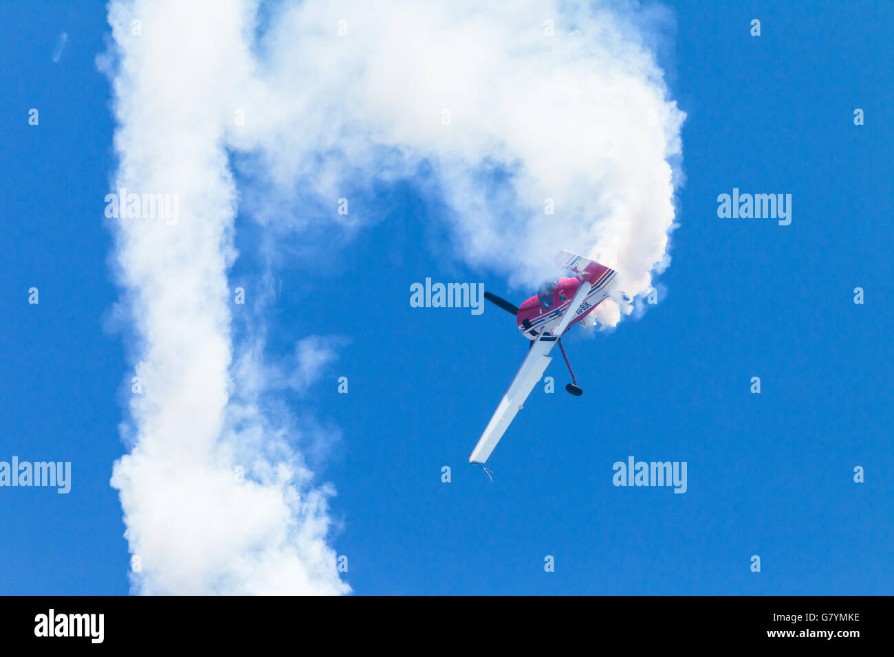 Aircraft acrobatics plane pilot flying action in blue sky closeup ...