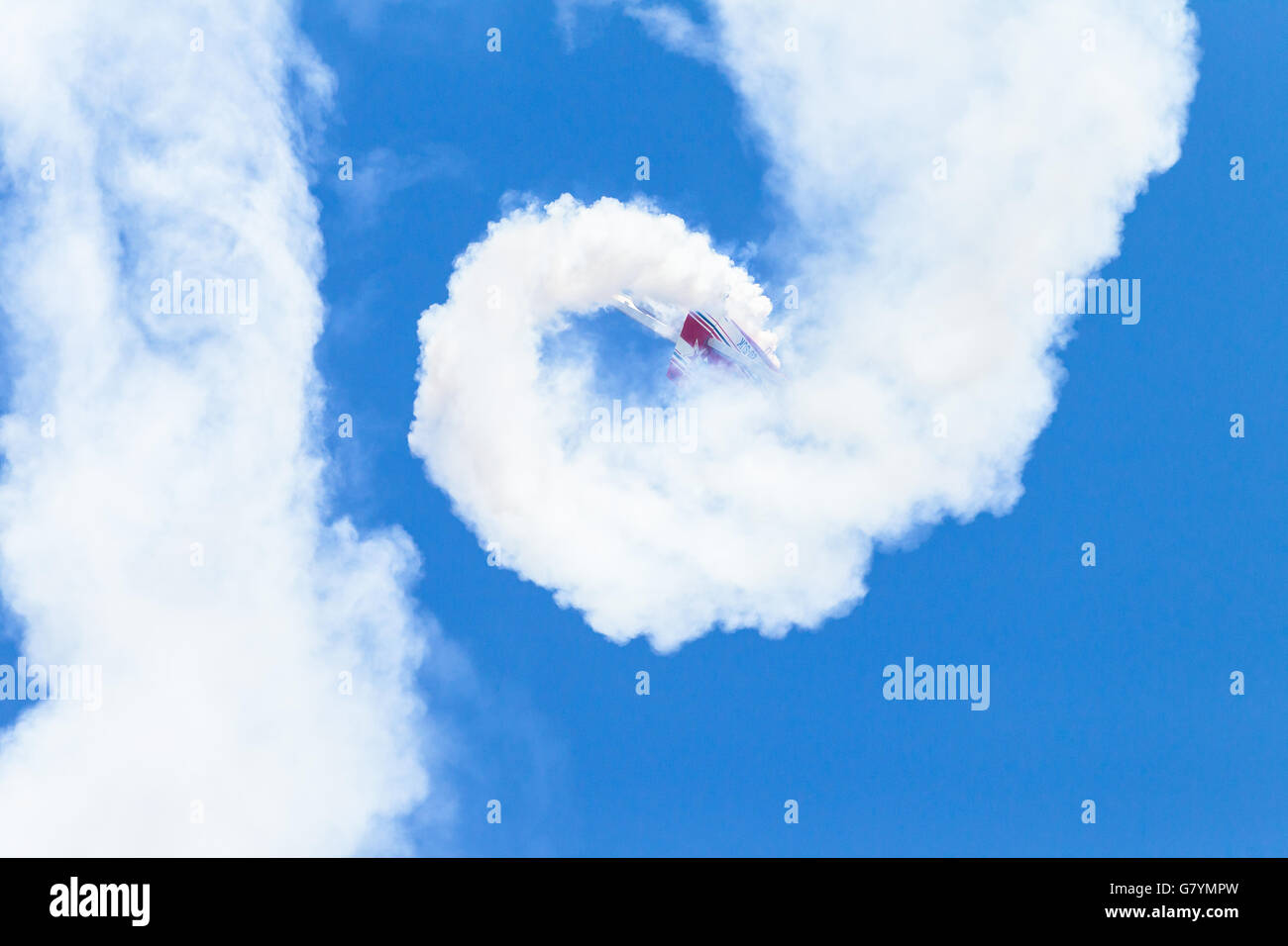 Aircraft acrobatics plane pilot flying action in blue sky closeup ...